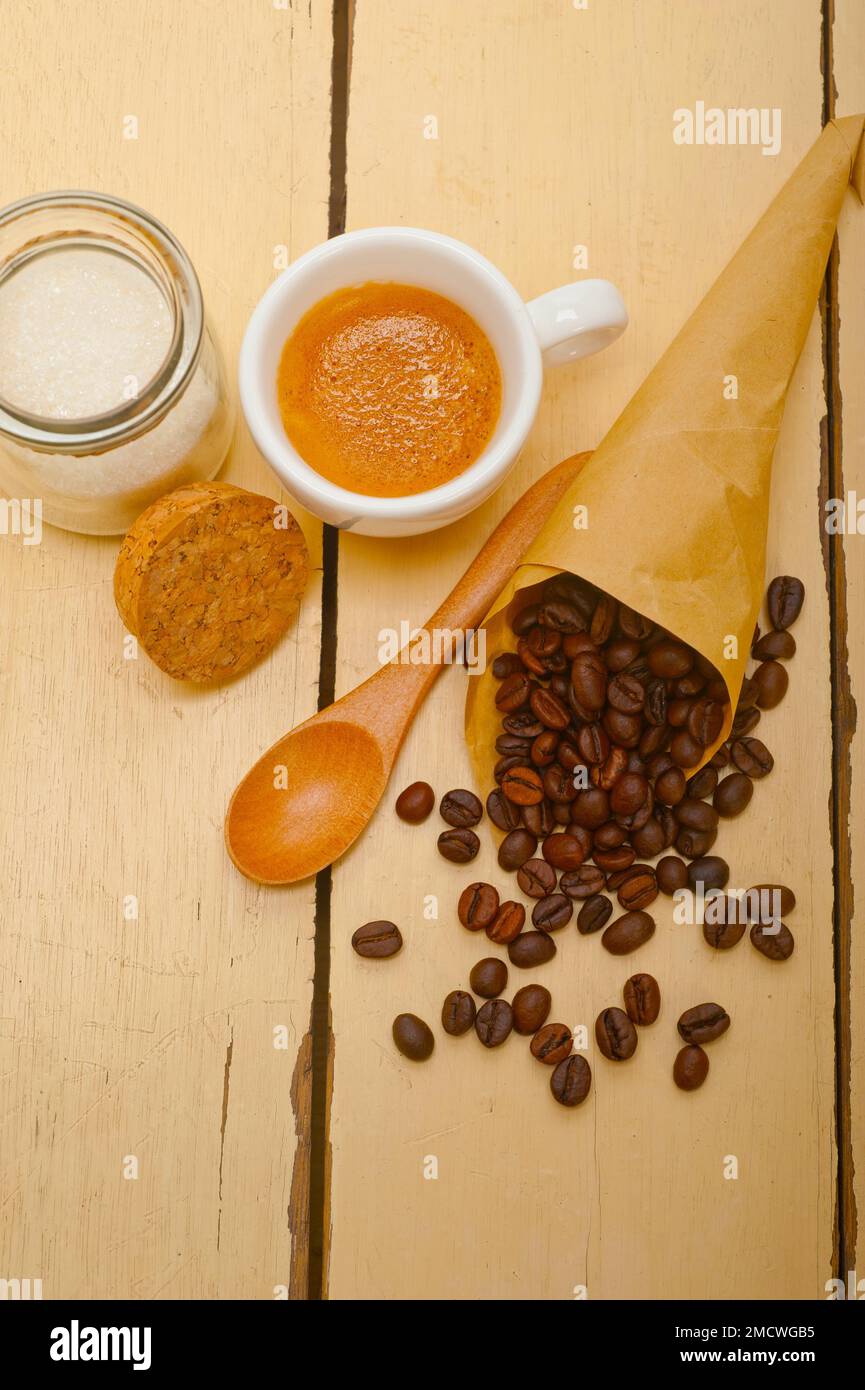 Espresso coffee and beans on a paper cone cornucopia over white ...