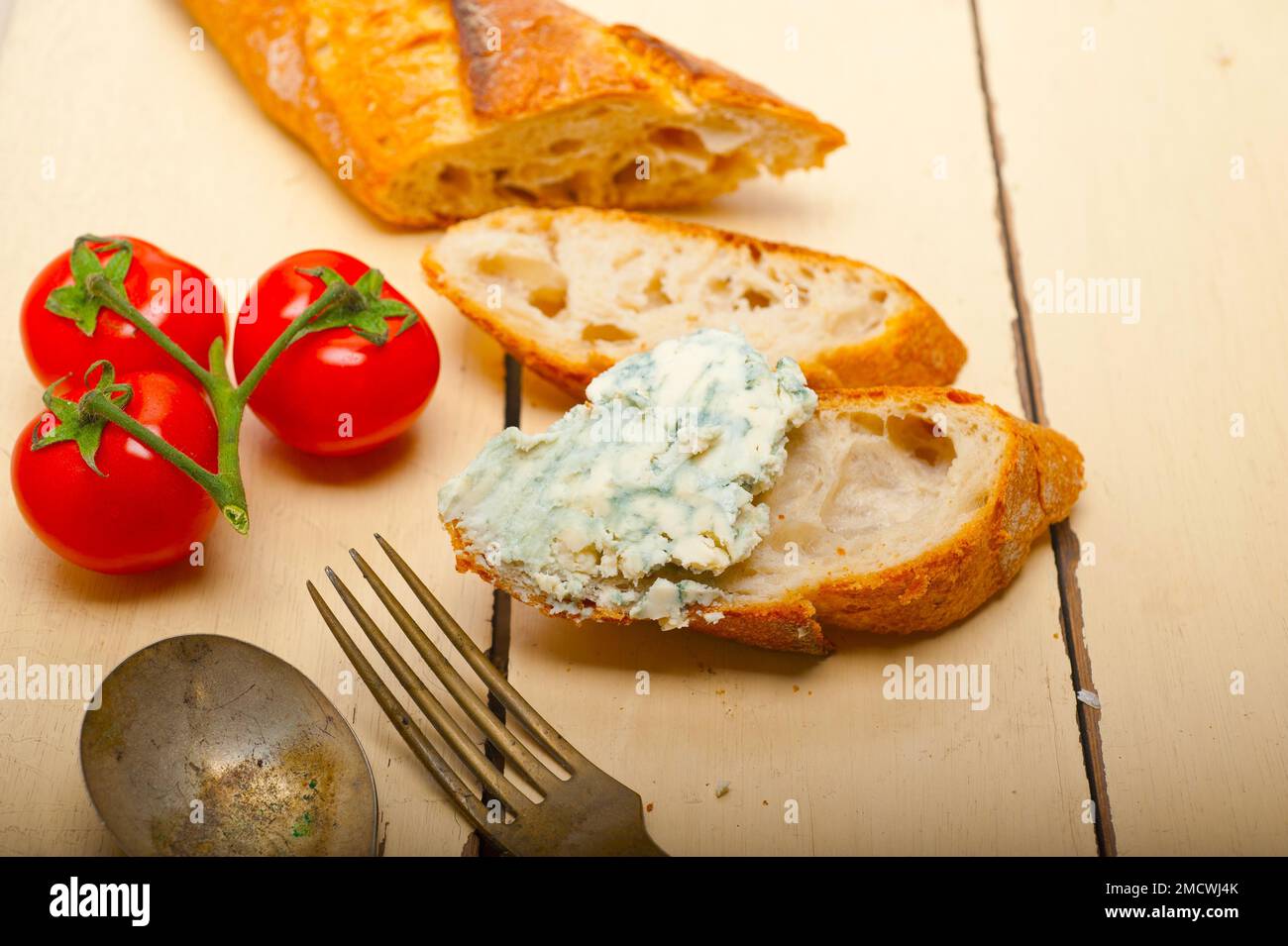 Fresh blue cheese spread ove french baguette with cherry tomatoes on ...