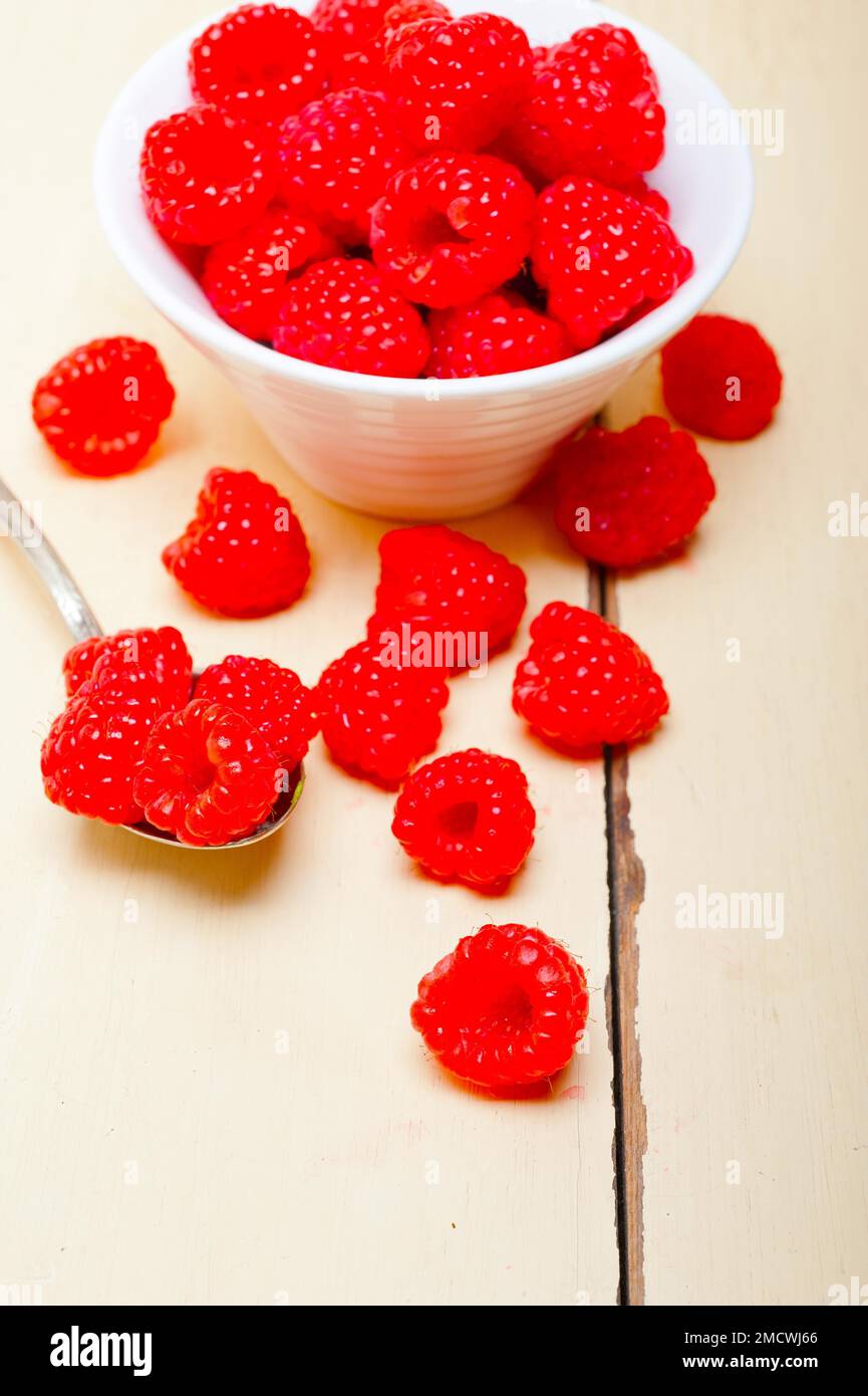 Bunch of fresh raspberry on a bowl and white wood rustic table Stock ...