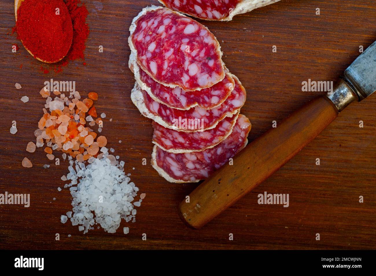 Traditional Italian salame cured sausage sliced on a wood board Stock ...