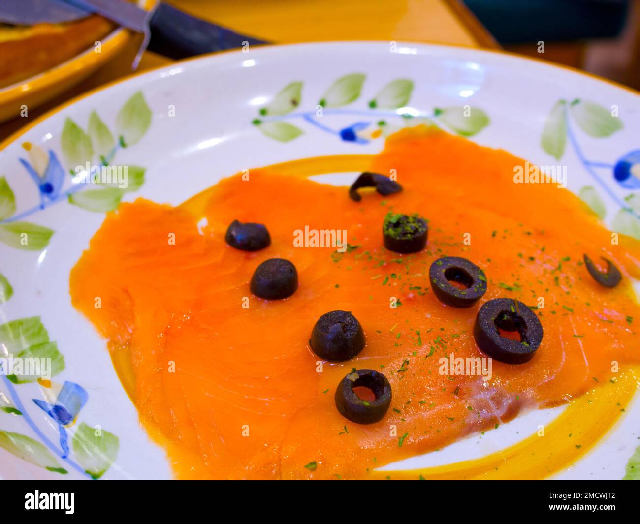 Norwegian smoked salmon with black olives on top Stock Photo - Alamy