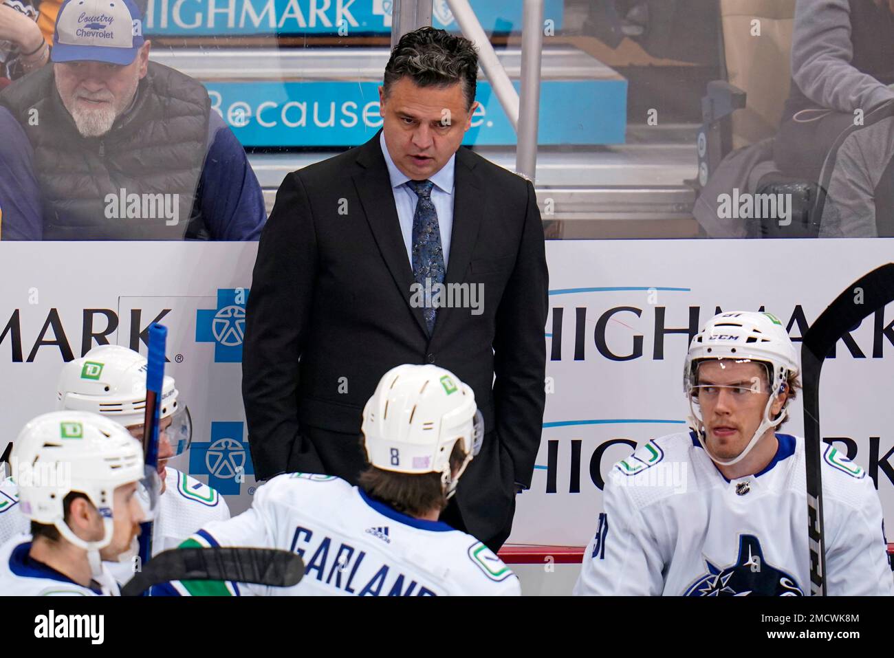 Vancouver Canucks head coach Travis Green stands behind his bench ...