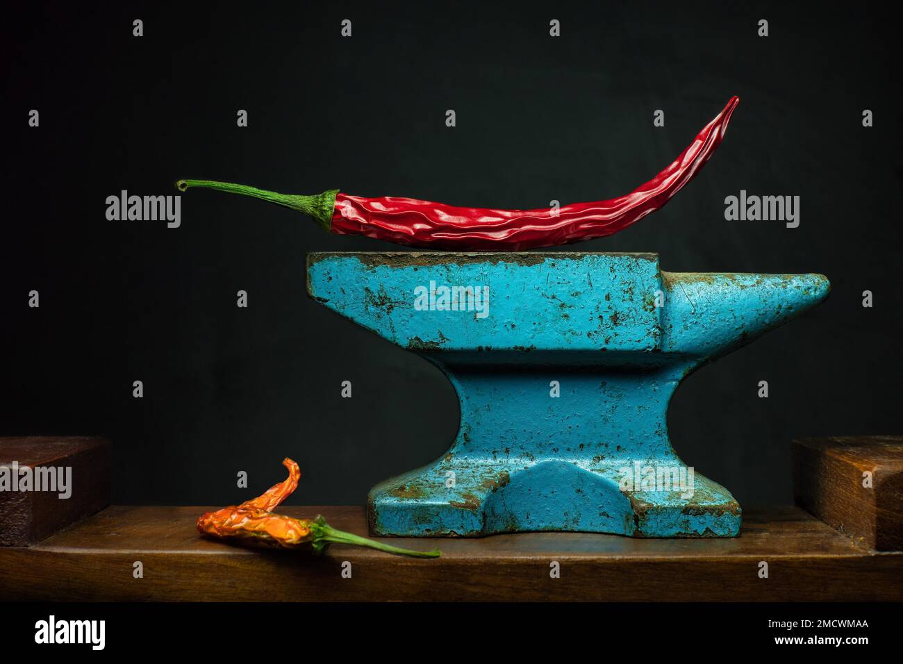 Food photography, still life with peppers on old blue anvil, studio ...