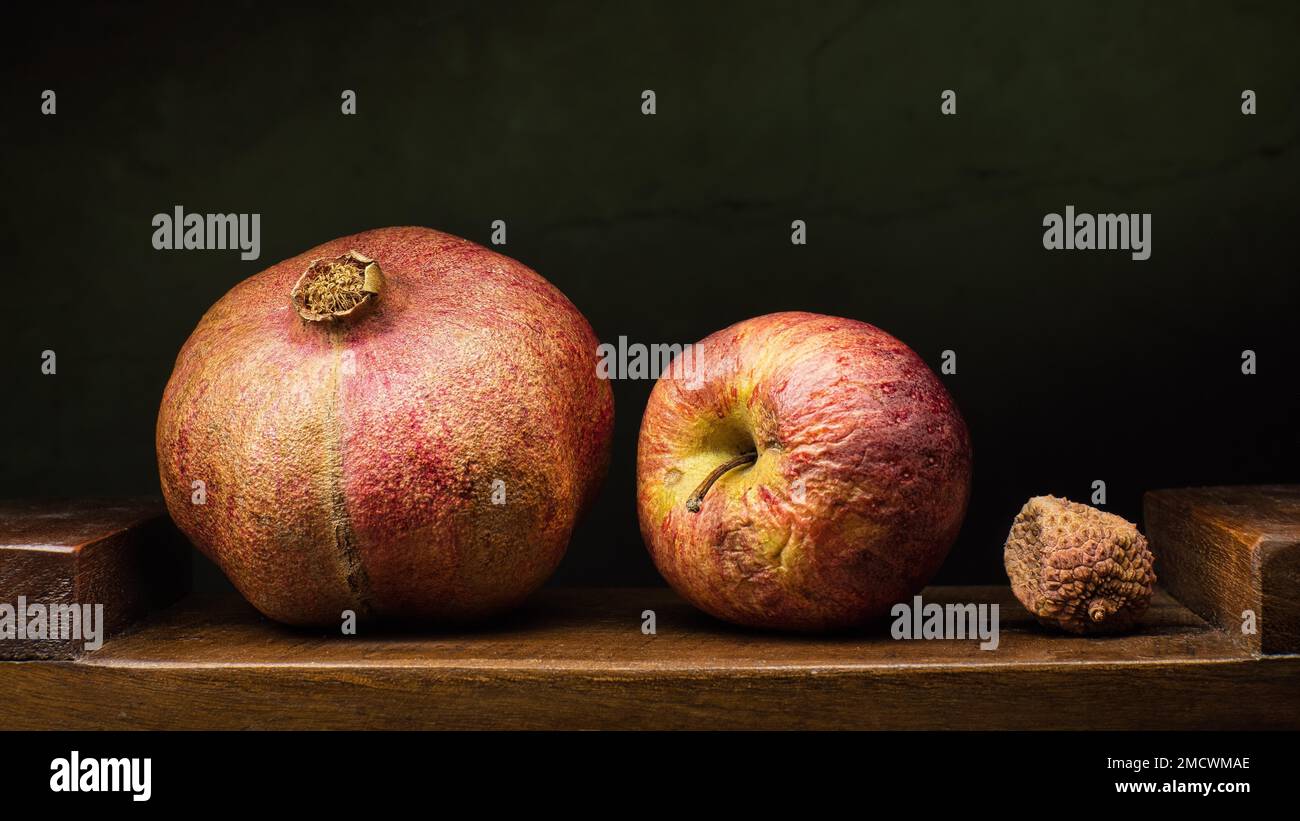 Food photography, still life with pomegranate, wrinkled apple and a ...