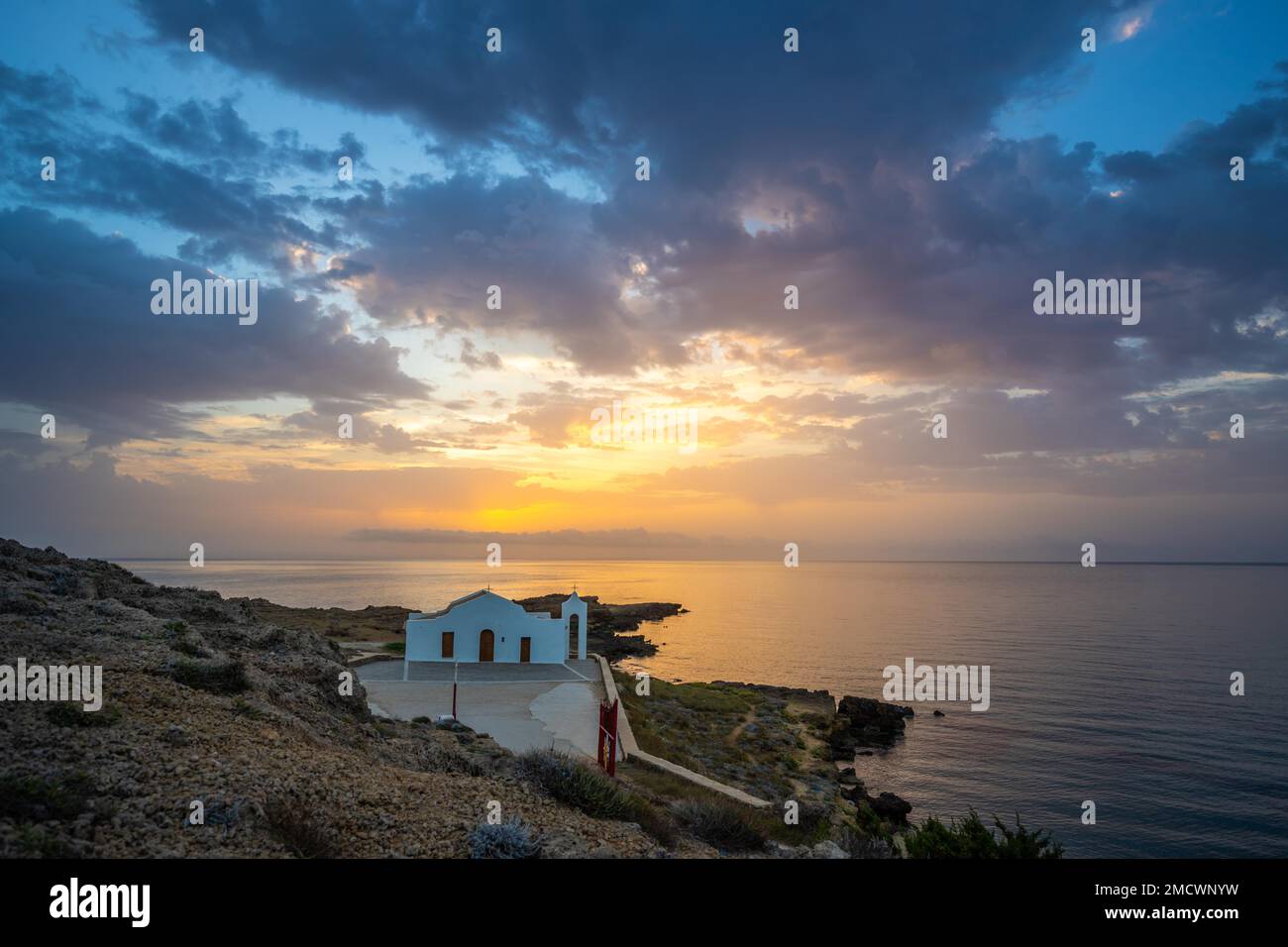 Small white Greek church by the sea at sunrise. Beautiful landscape ...