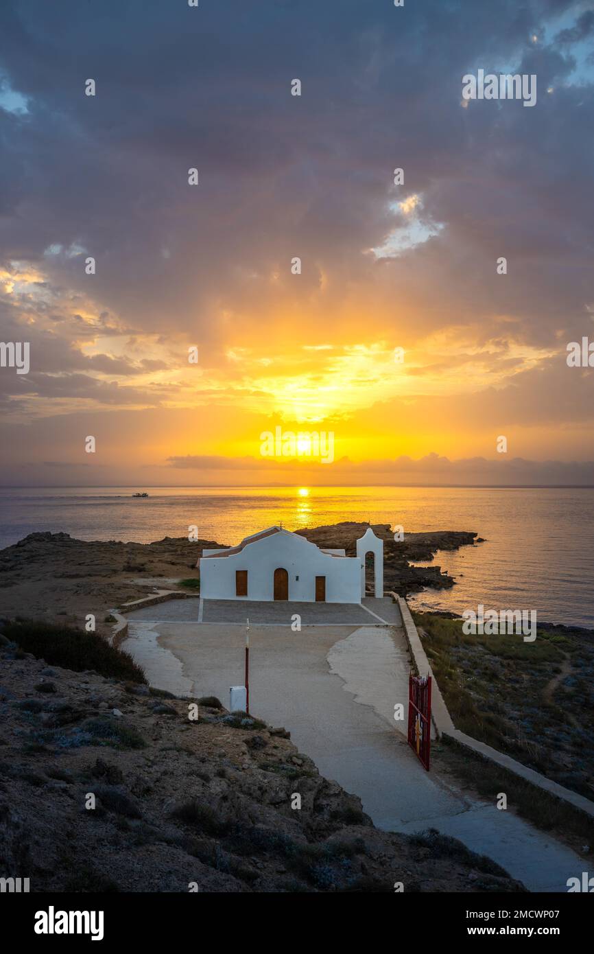 Small white Greek church by the sea at sunrise. Beautiful landscape ...
