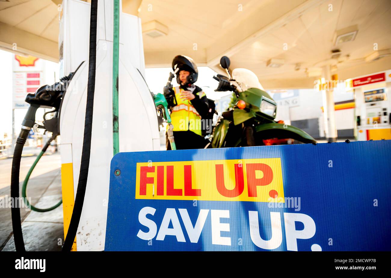 A motorcyclist fills up with gas at a Shell station on Monday, Nov. 22 ...