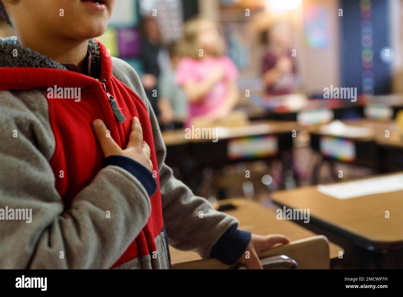 Ali Patan, 7, holds his hand to his chest while reciting the Pledge of ...