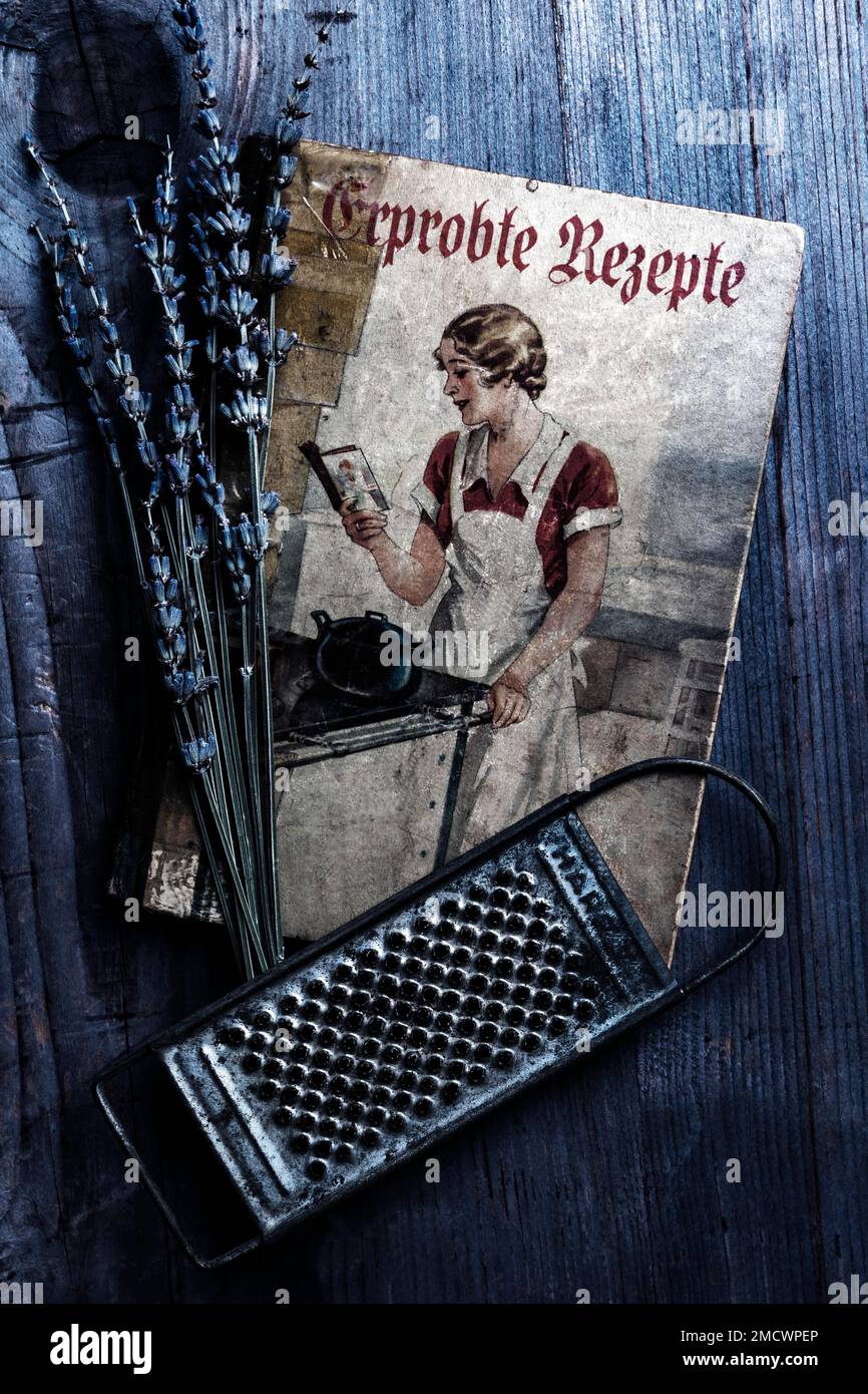 Old cookbook with lavender and kitchen grater on rustic background ...