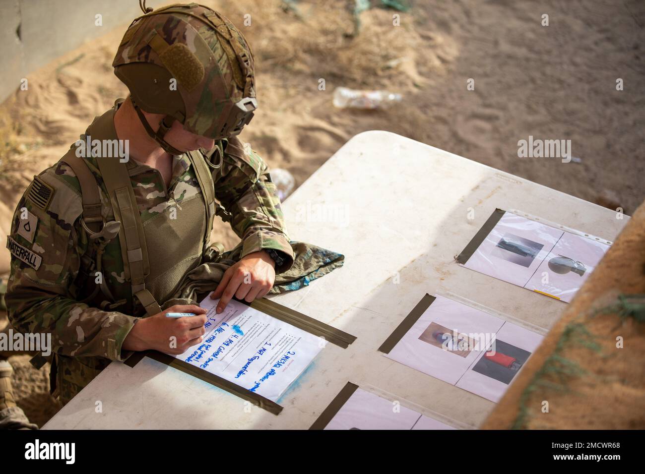A U.S. Soldier writes on an Expert Soldier Badge (ESB) exam sheet at ...