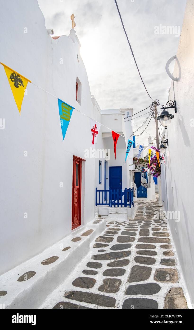 Cycladic Greek Orthodox Church decorated with flags, alleys of the old ...