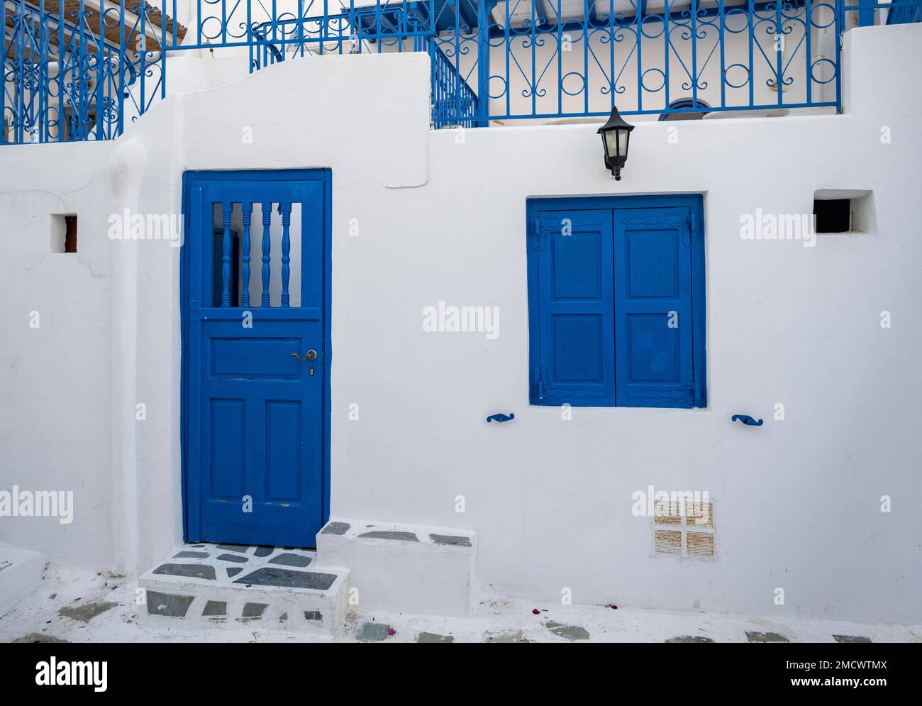 House facade with blue entrance door and shutters, Cycladic white ...