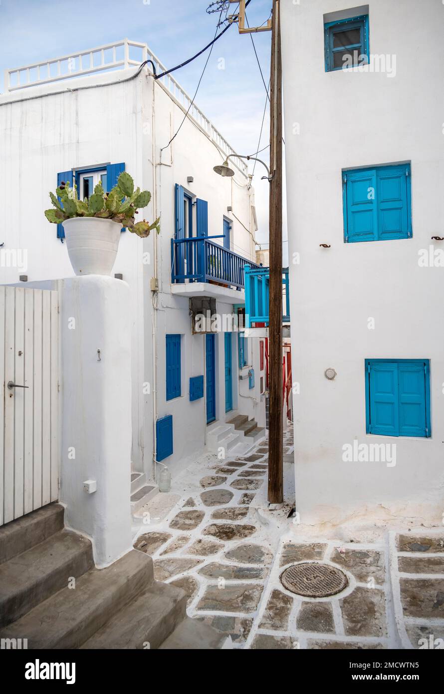 Cycladic white houses with blue shutters and bougainvillea, alleys of ...