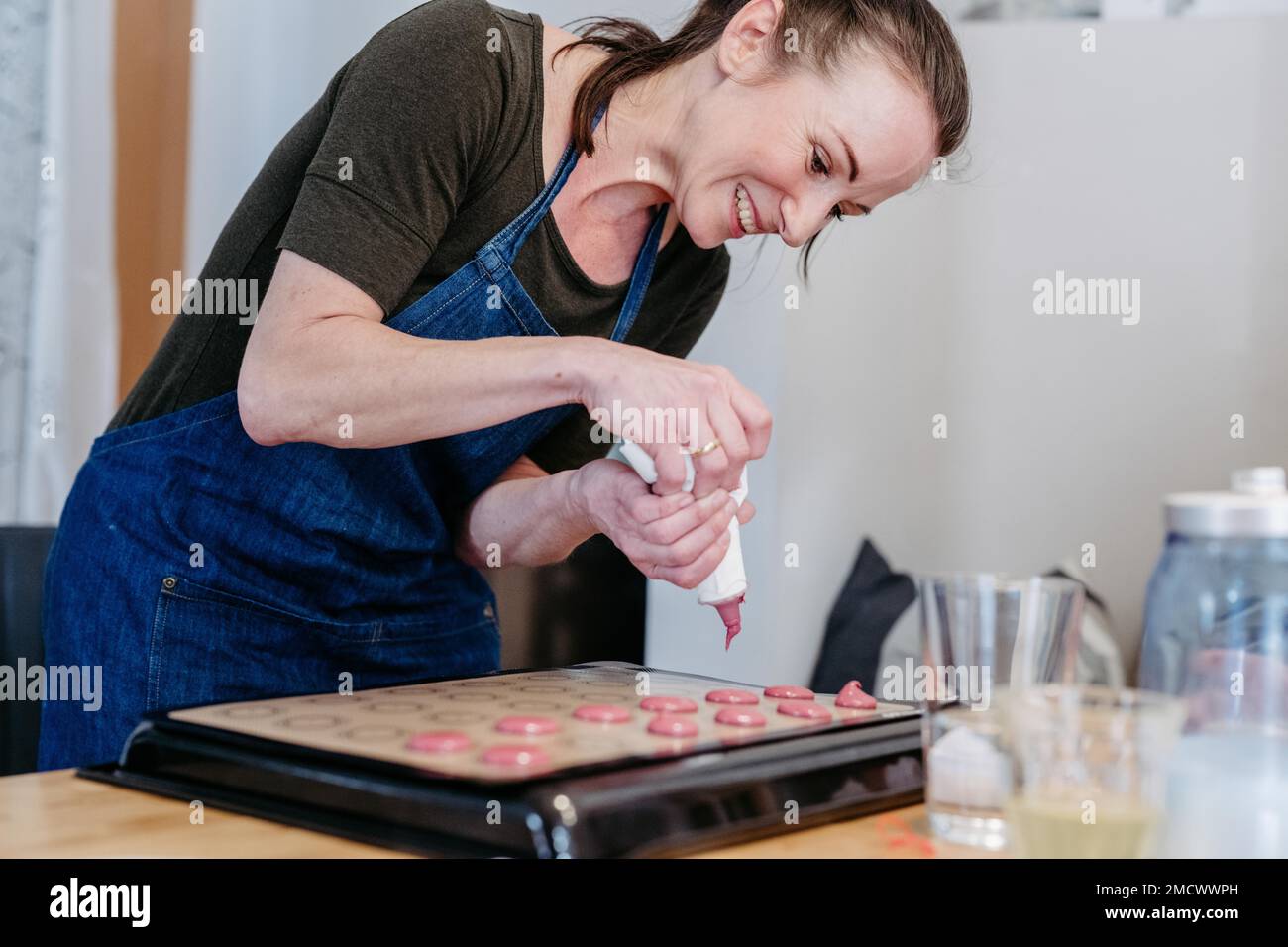 Woman baking macrones Stock Photo - Alamy