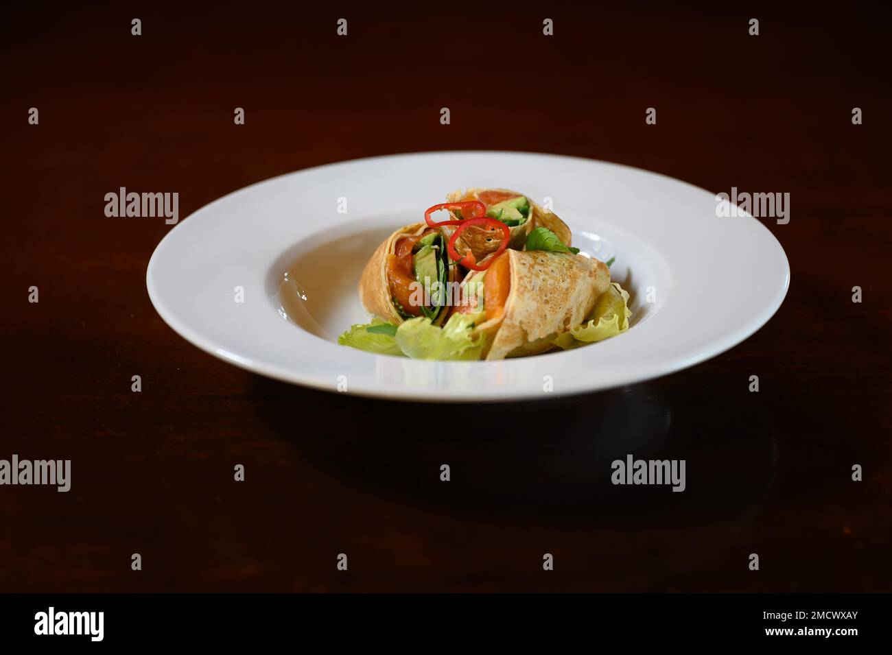 Mediterranean spring roll served on a white plate Stock Photo - Alamy