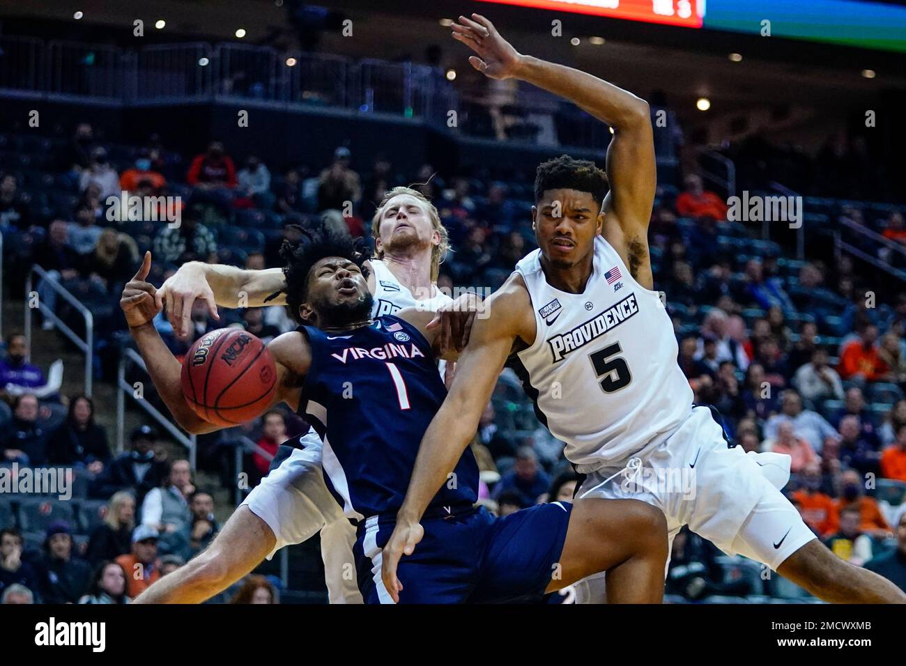 Providence's Ed Croswell (5) and Noah Horchler defend a shot by ...