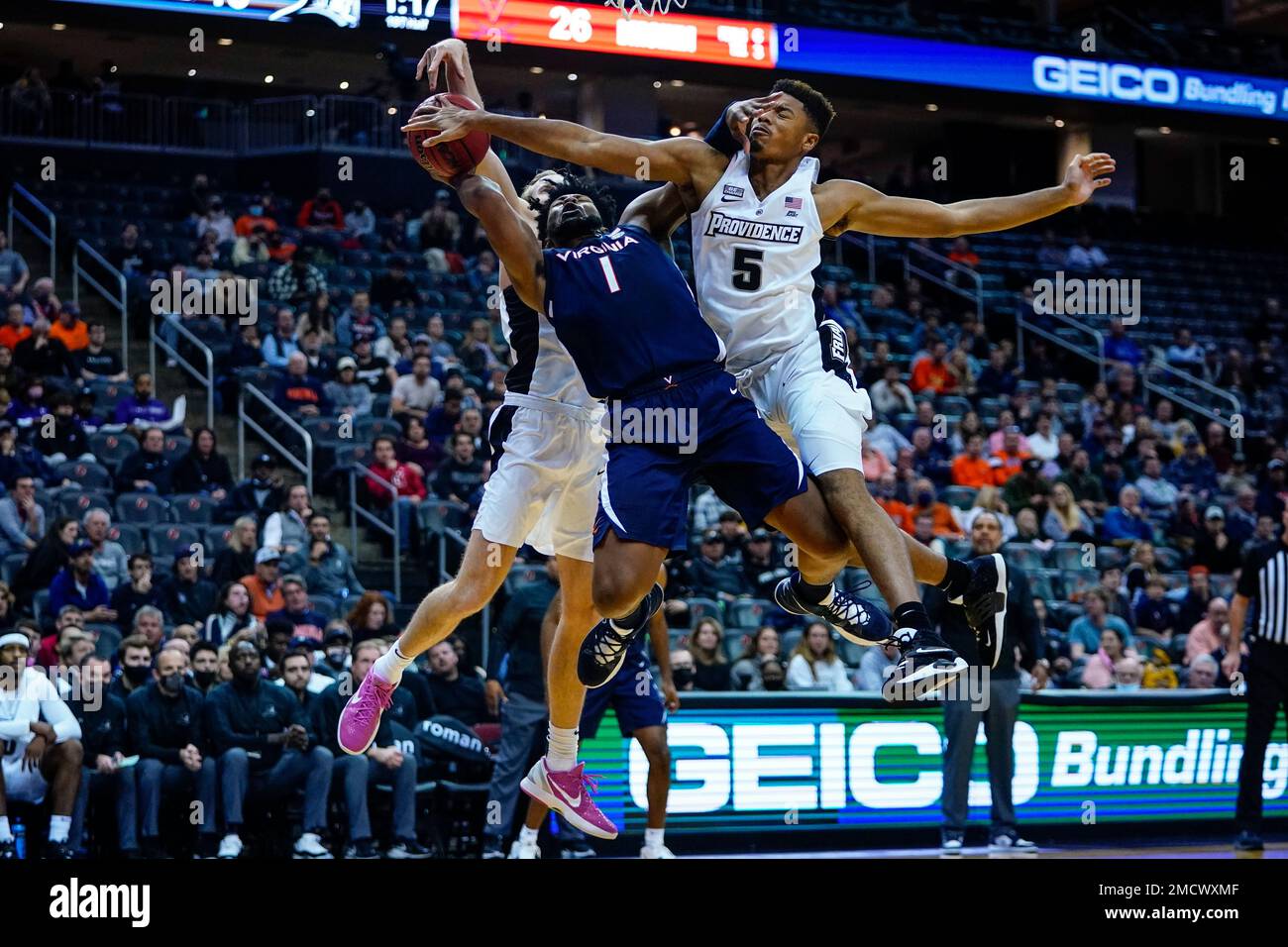Providence's Ed Croswell (5) and Noah Horchler defend a shot by ...