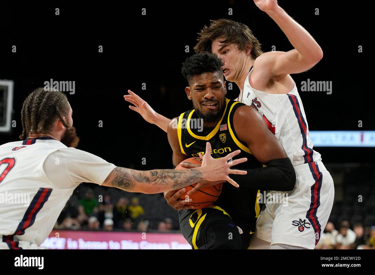 Oregon forward Quincy Guerrier drives between St. Mary's guard Logan ...