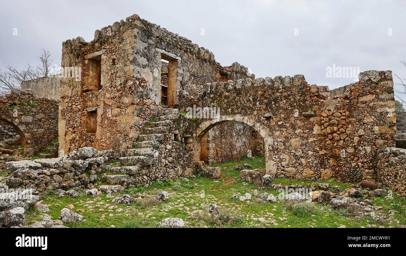 Spring in Crete, ruined houses, green vegetation, cloudy sky, abandoned ...