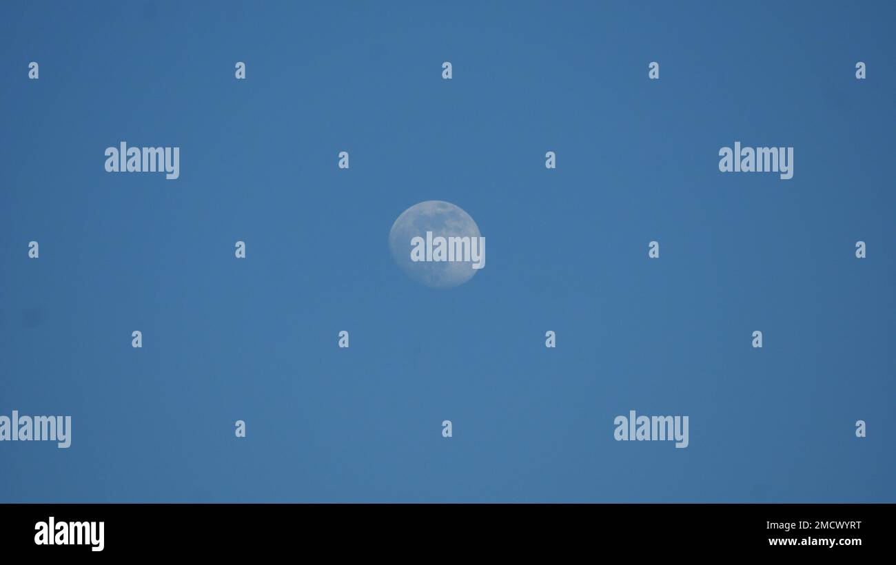 The daylight white full moon isolated in the clear blue sky - perfect wallpaper Stock Photo - Alamy