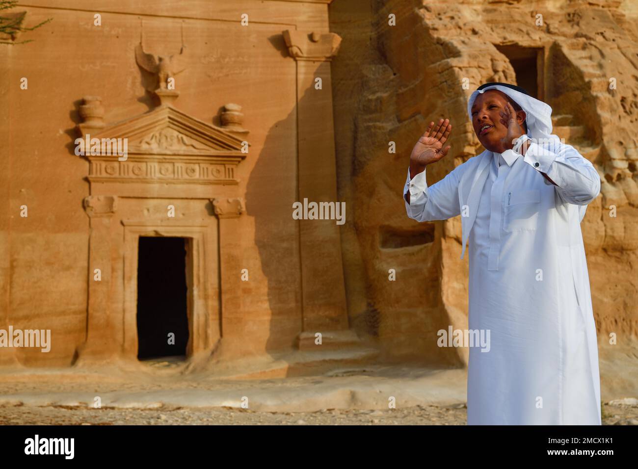 Rawi, storyteller, in front of the Nabataean tombs at the rock Qasr Al ...