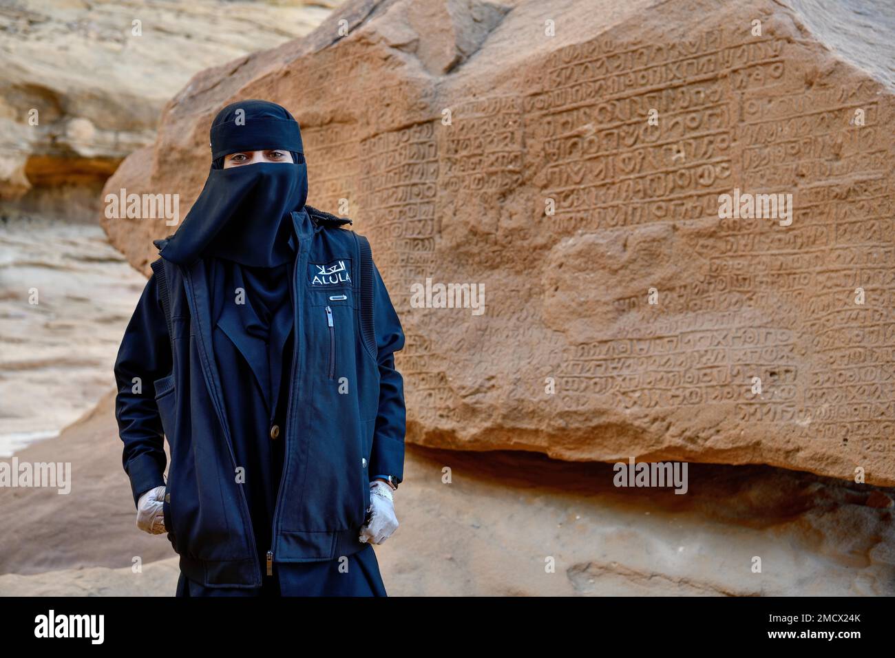 Local tour guide in front of the inscriptions from the Dadanite period ...
