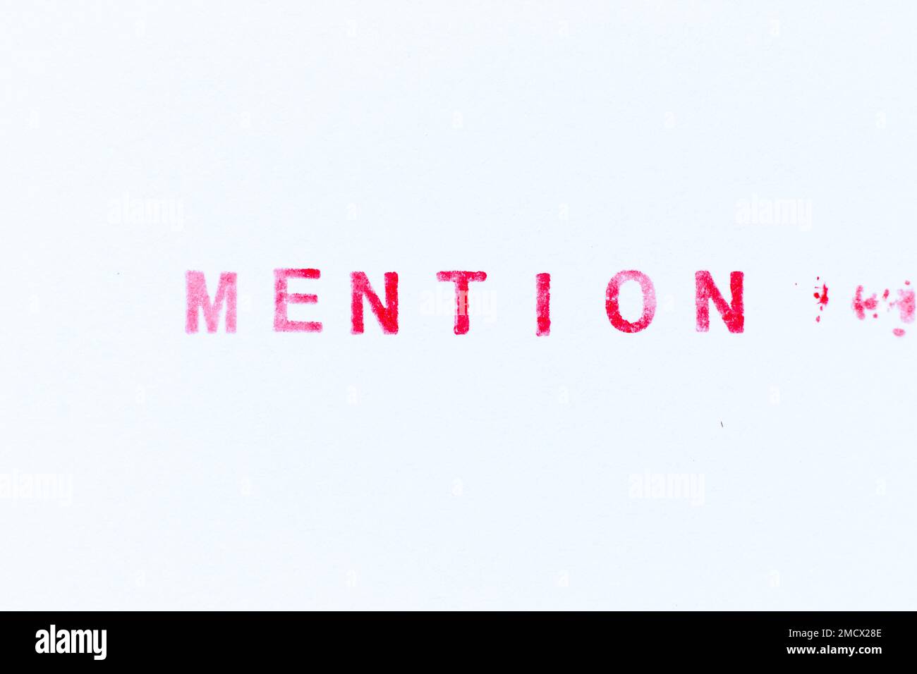 Red color ink rubber stamp in word mention on white paper background ...