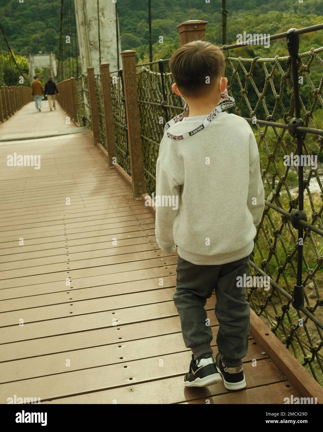 Kid walking on the flying bridge Stock Photo - Alamy