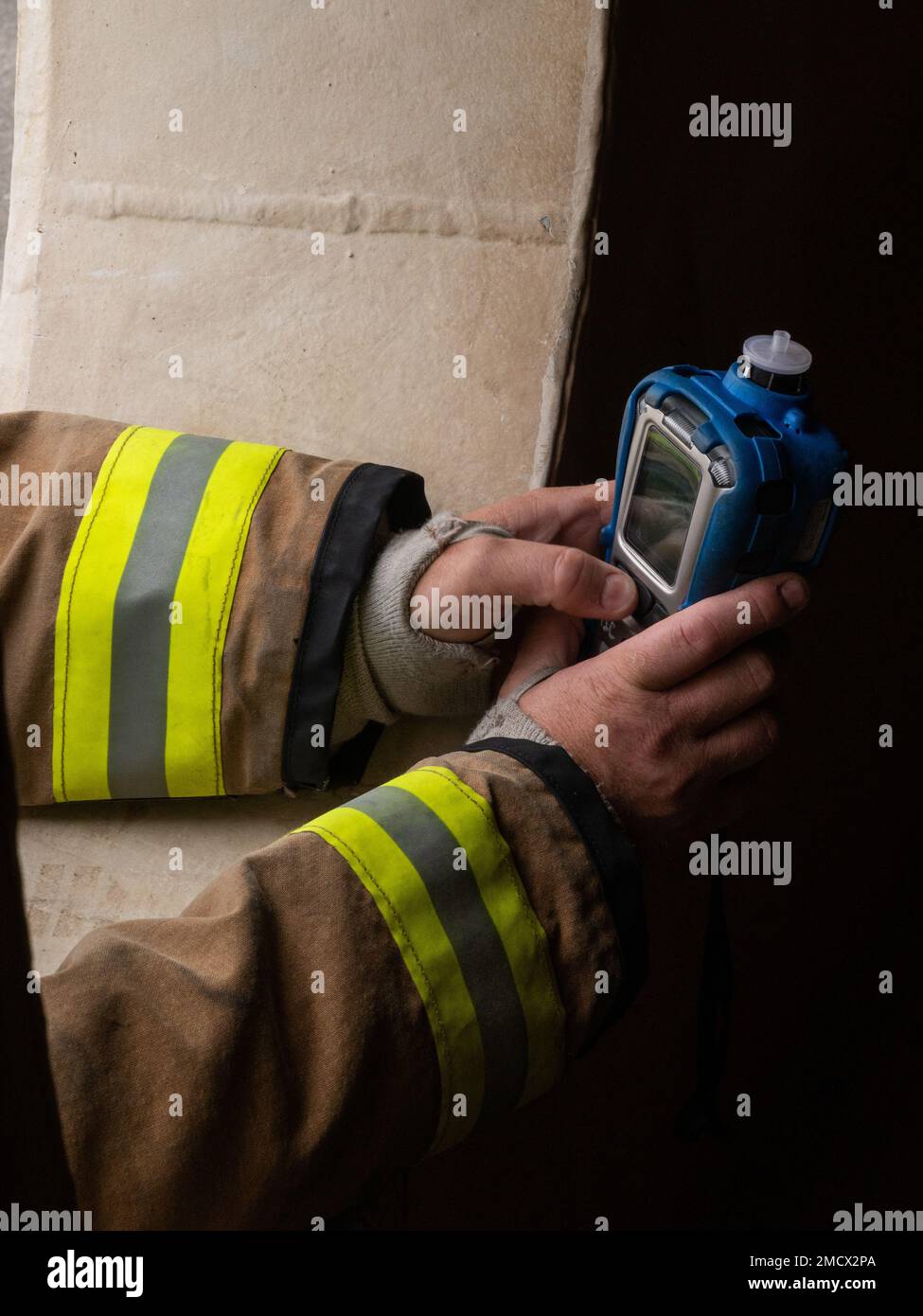 A firefighter with the 914th Fire Emergency Services holds a multi-gas ...
