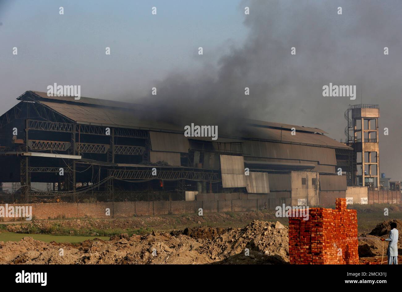 FILE - Smoke pours out of a steel factory in Lahore, Pakistan, Monday ...