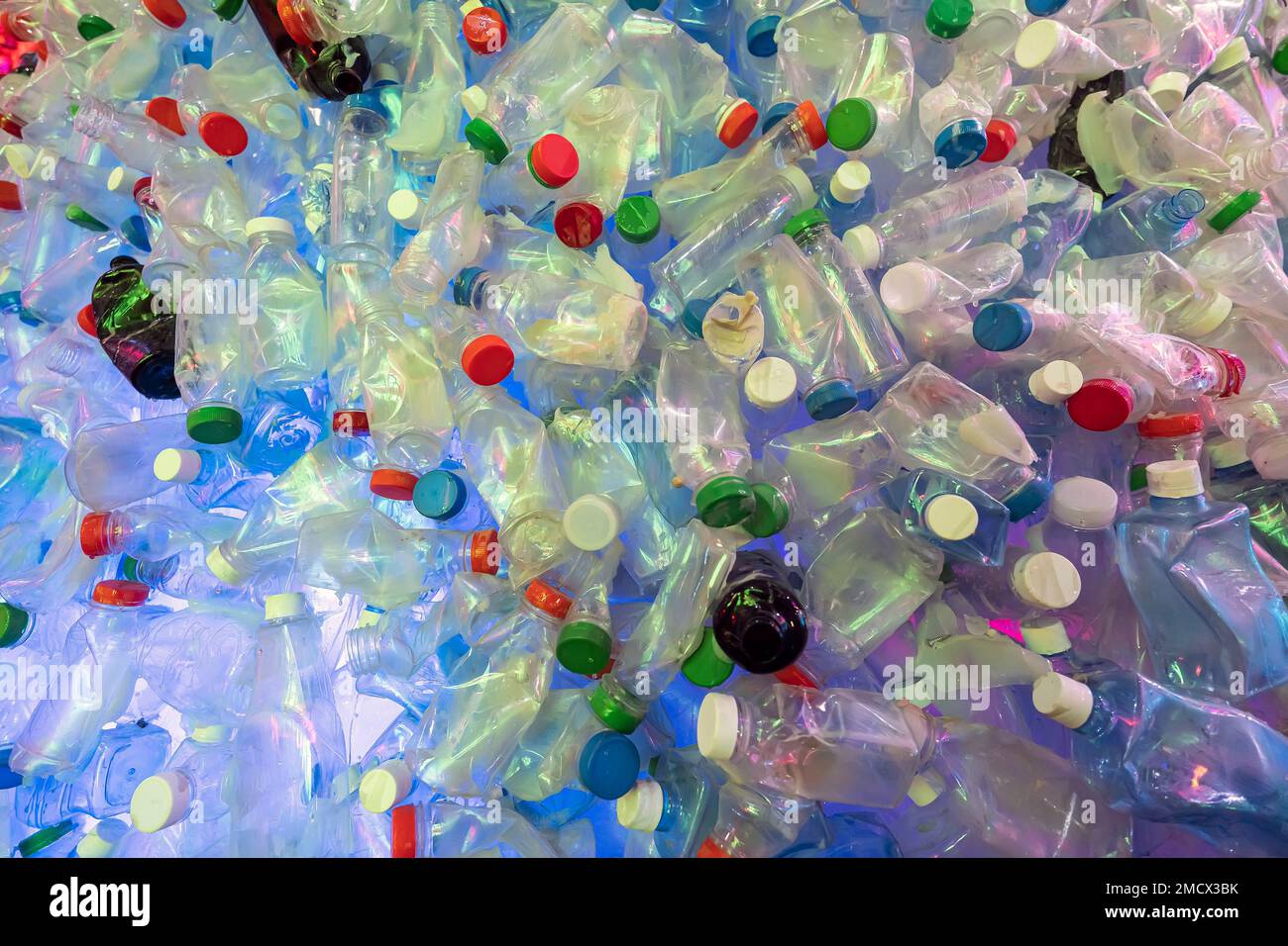 multicolored background of plastic bottles. The problem of plastic ...