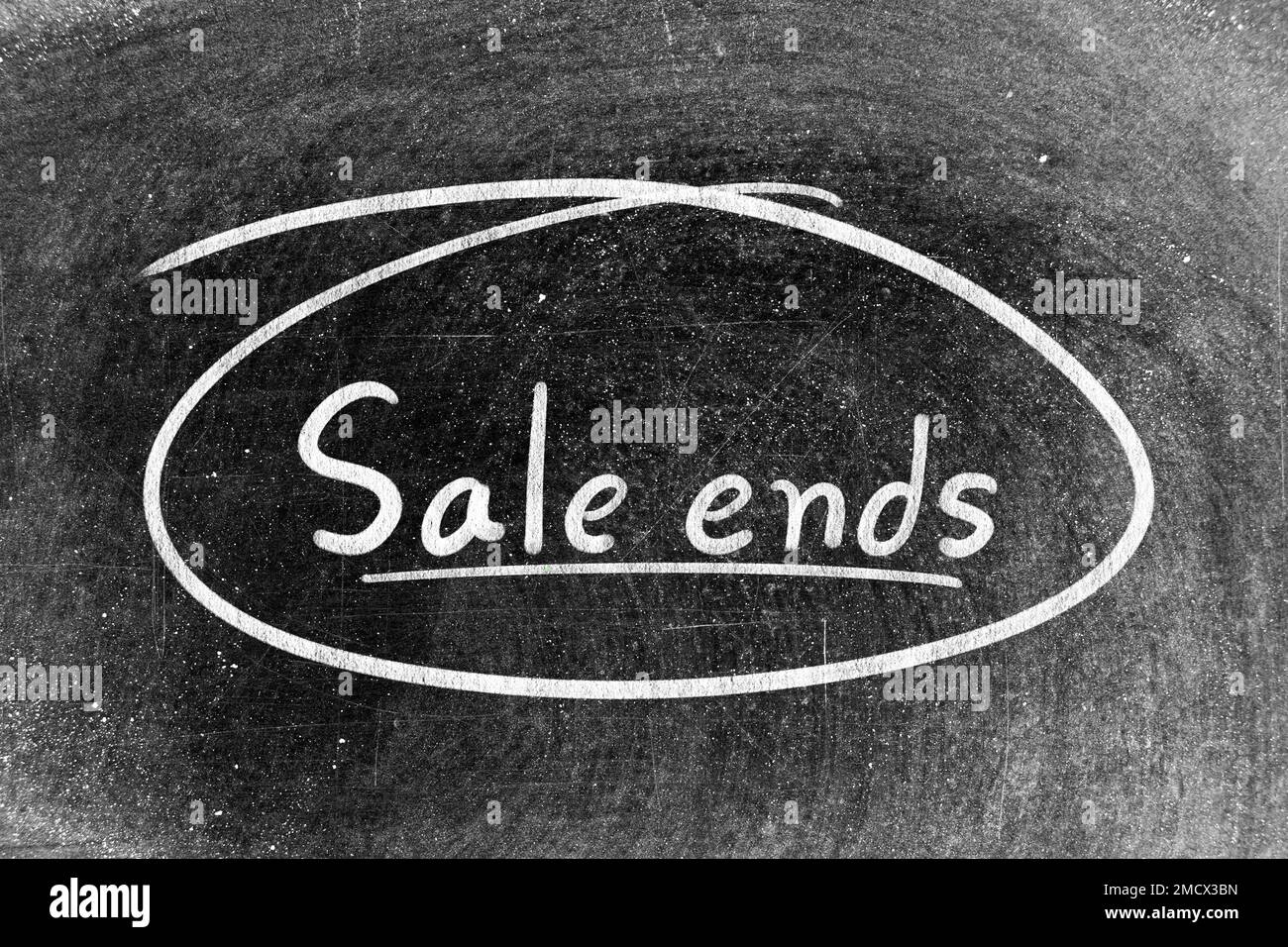 White chalk hand writing in word sale ends and circle shape on ...