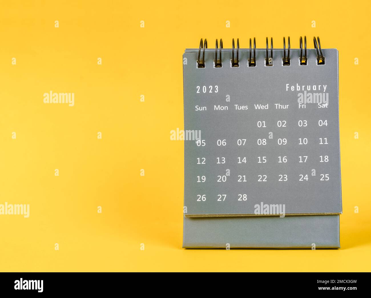 February 2023 desk calendar for 2023 year on yellow color background ...