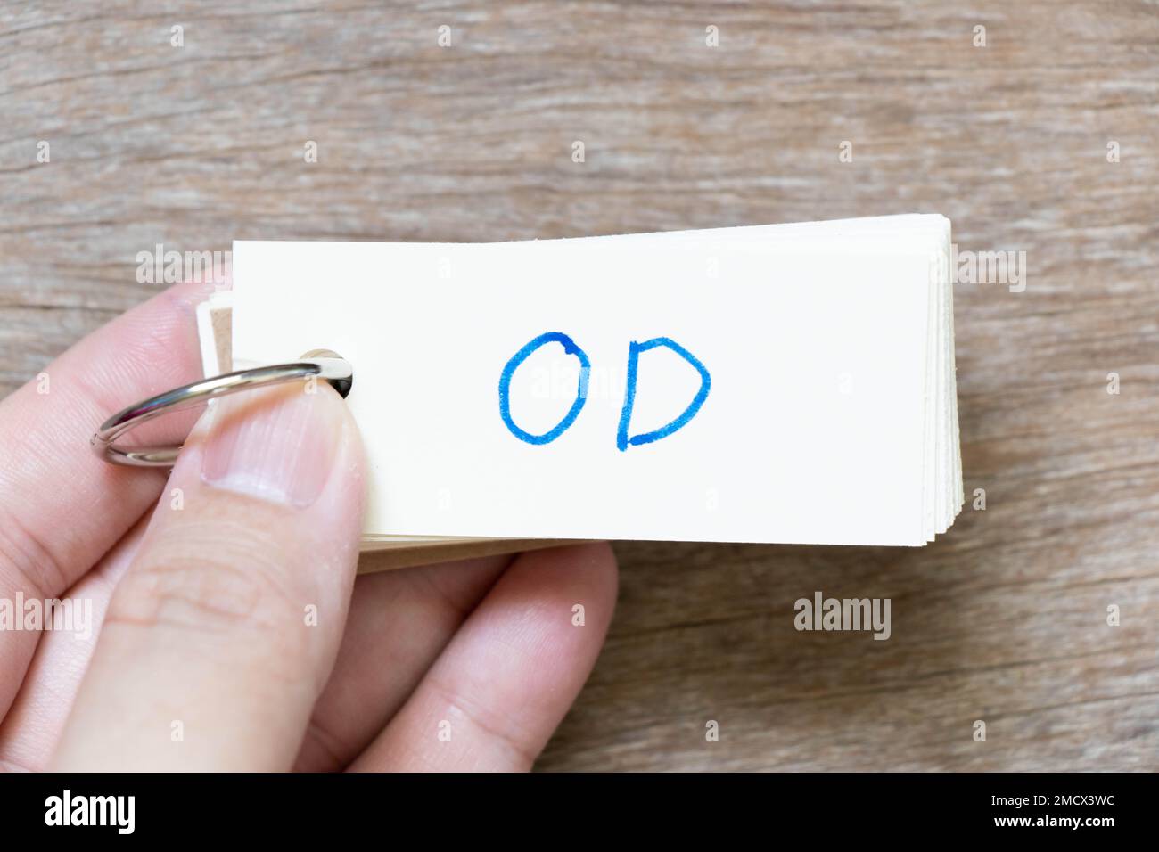 Hand hold flash card with handwriting in word OD (Abbreviation of ...