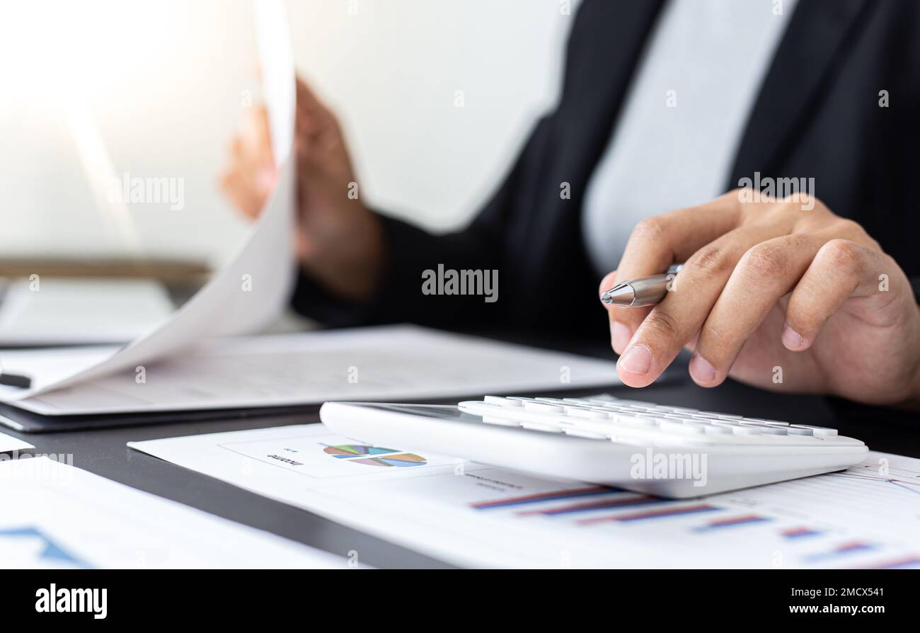 Accounting businessmen are calculating income-expenditure and analyzing ...