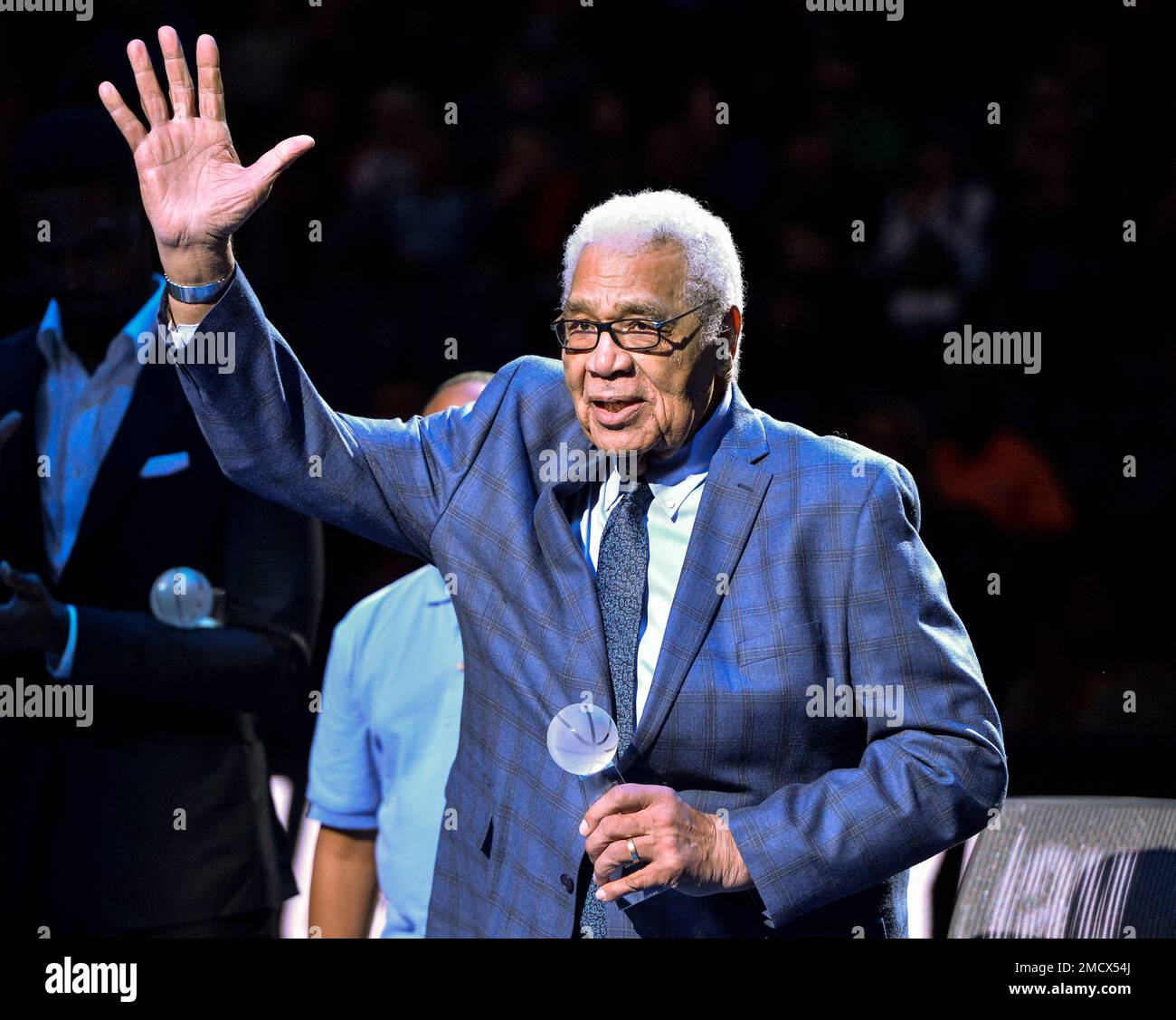 FILE - Wayne Embry raises his hand as he stands with fellow recipients ...
