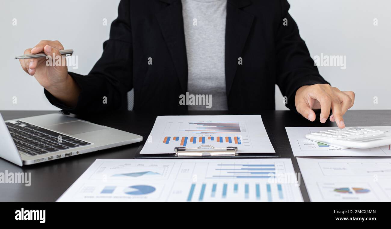 Accounting businessmen are calculating income-expenditure and analyzing ...