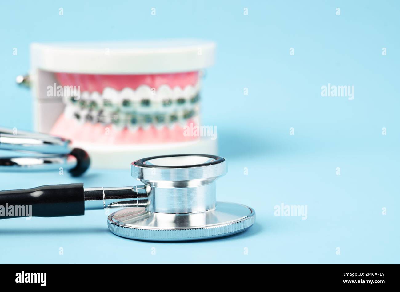 Medicine equipment stethoscope and metal wire dental braces on model ...
