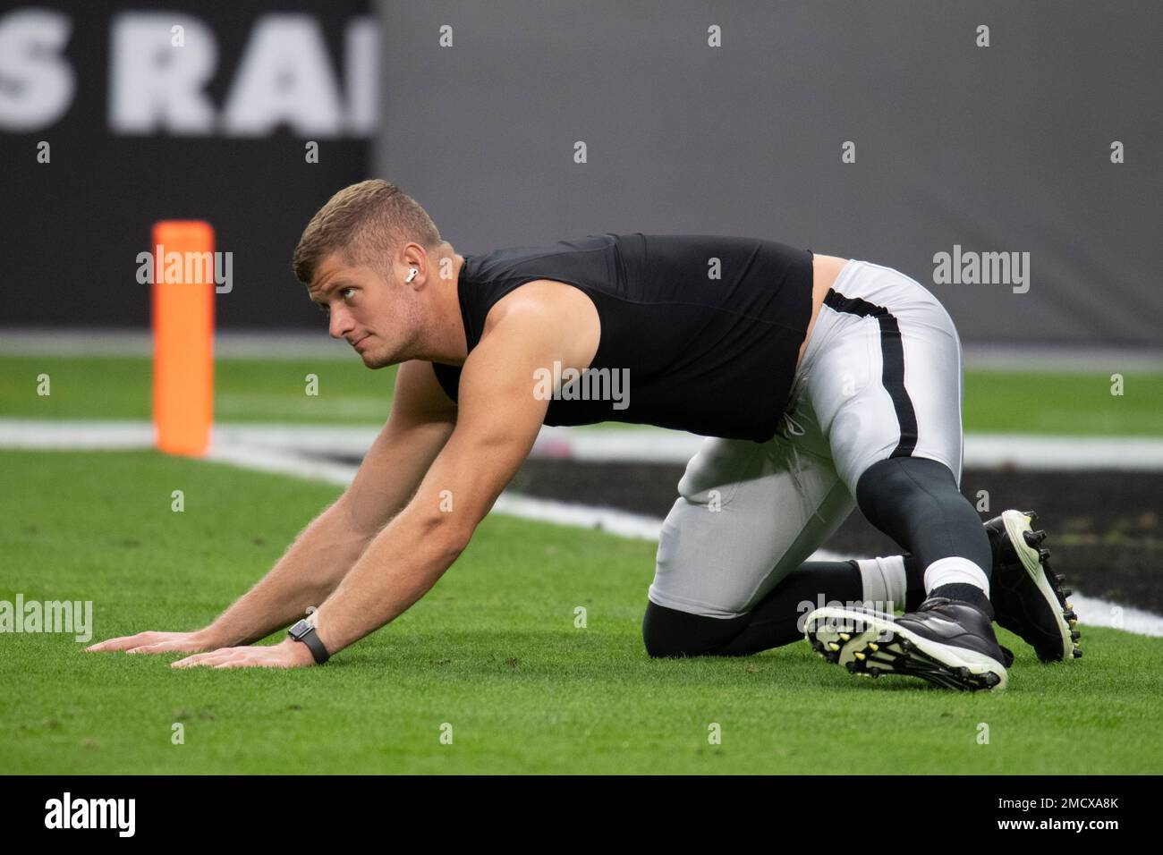 Las Vegas Raiders defensive end Carl Nassib (94) stretches with his helmet off before playing ...