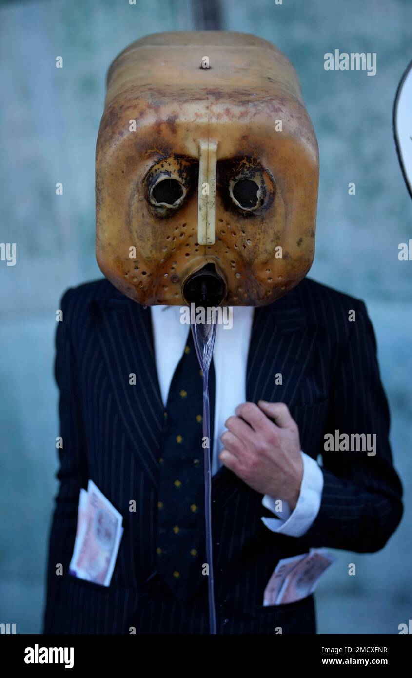 An activist from the environment group Ocean Rebellion performs a ...