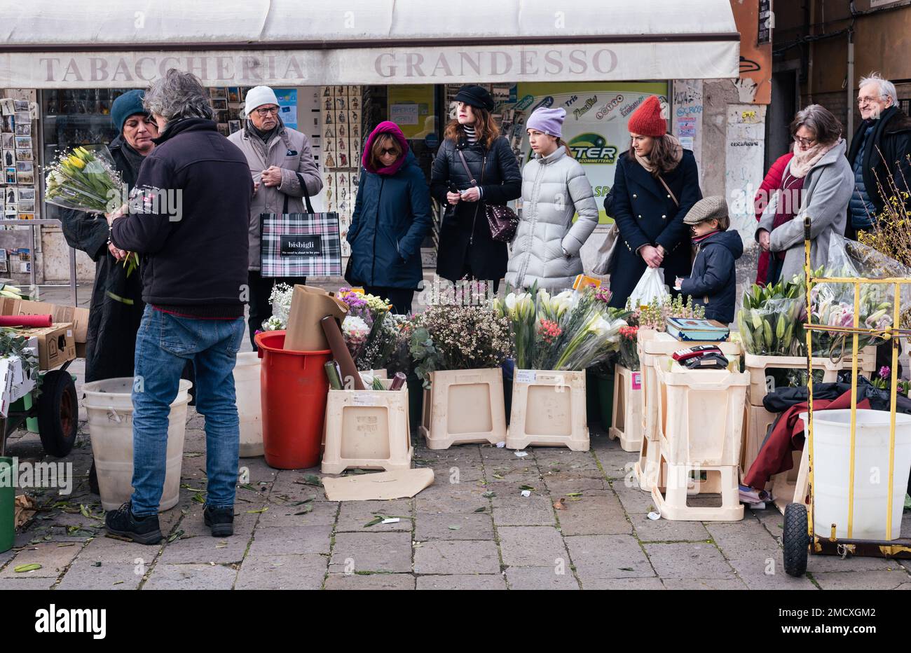 21 January, 2023. Italians dressed in winter clothes queue at a flower ...