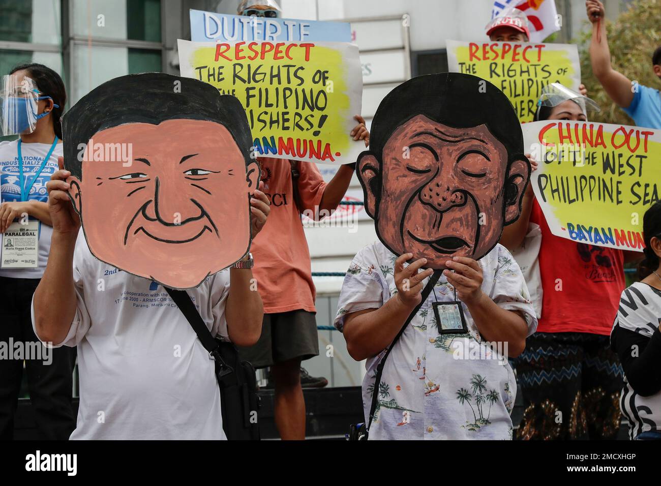 FILE - Protesters wear a mask of Philippine President Rodrigo Duterte ...