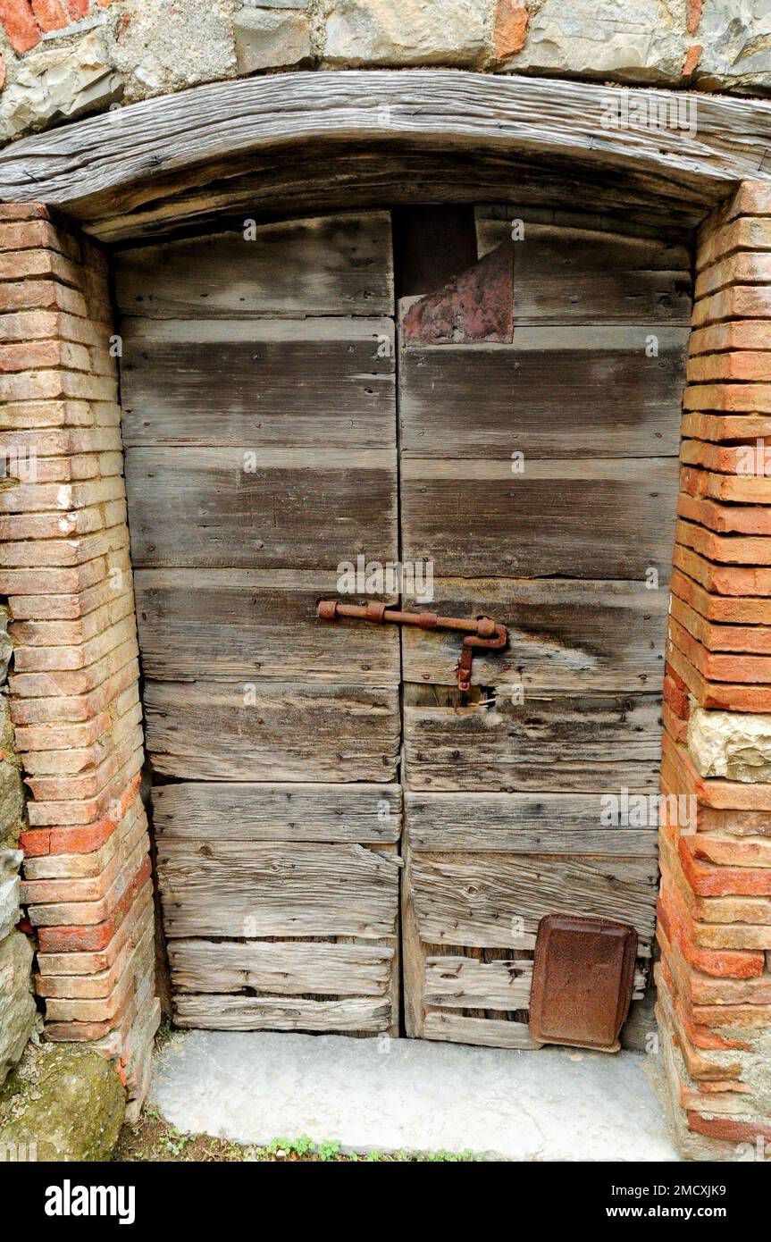 Rustic wooden door with large rusty bolt, Roccatederighi Mountain ...