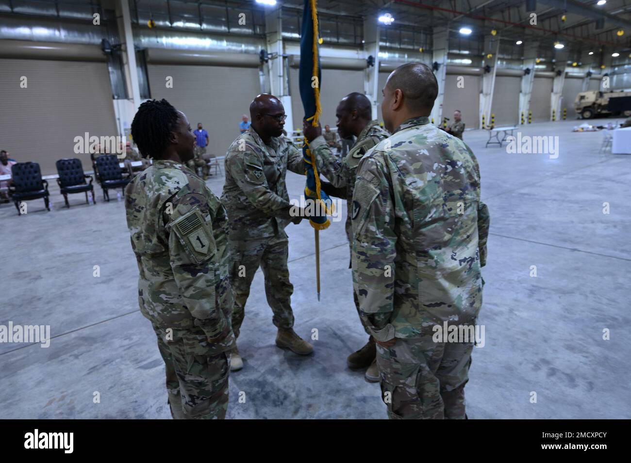 Col. Anthony E. Hughkey, 408th Contracting commander, passes the guide ...