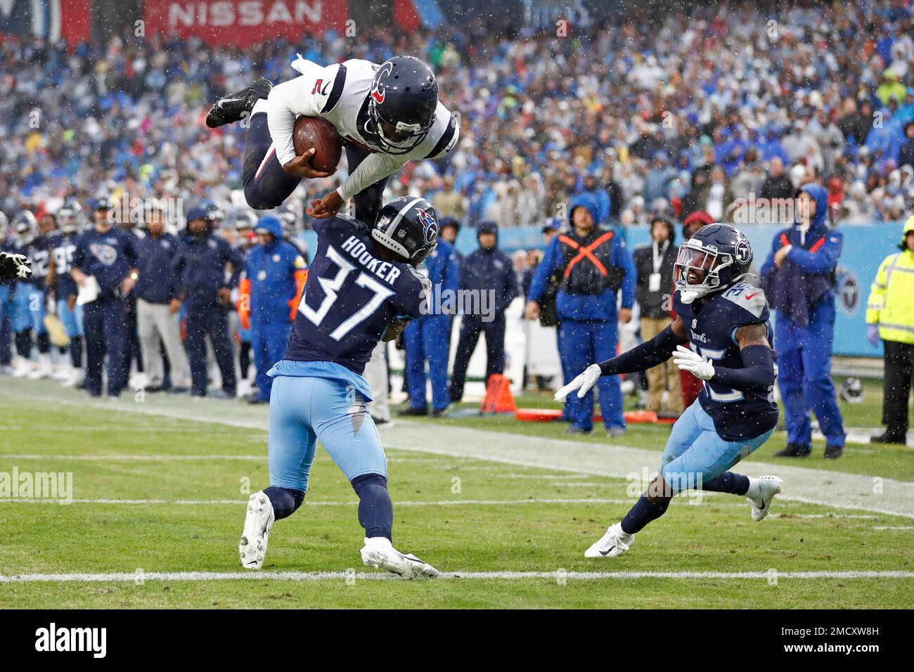 Houston Texans quarterback Tyrod Taylor, top, leaps over Tennessee ...