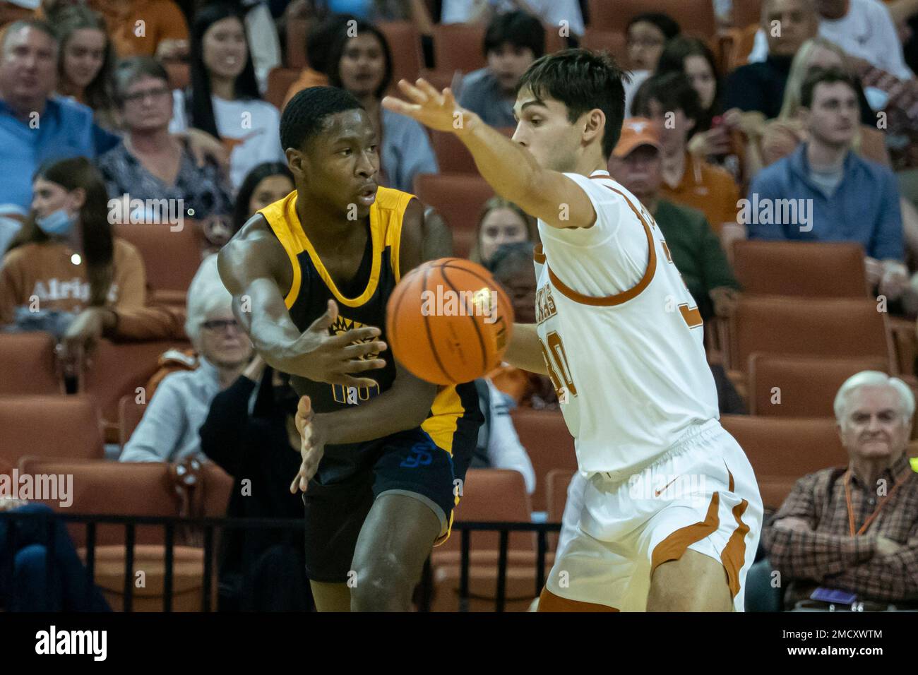 San Jose State guard Omari Moore, left, passed the ball against Texas ...