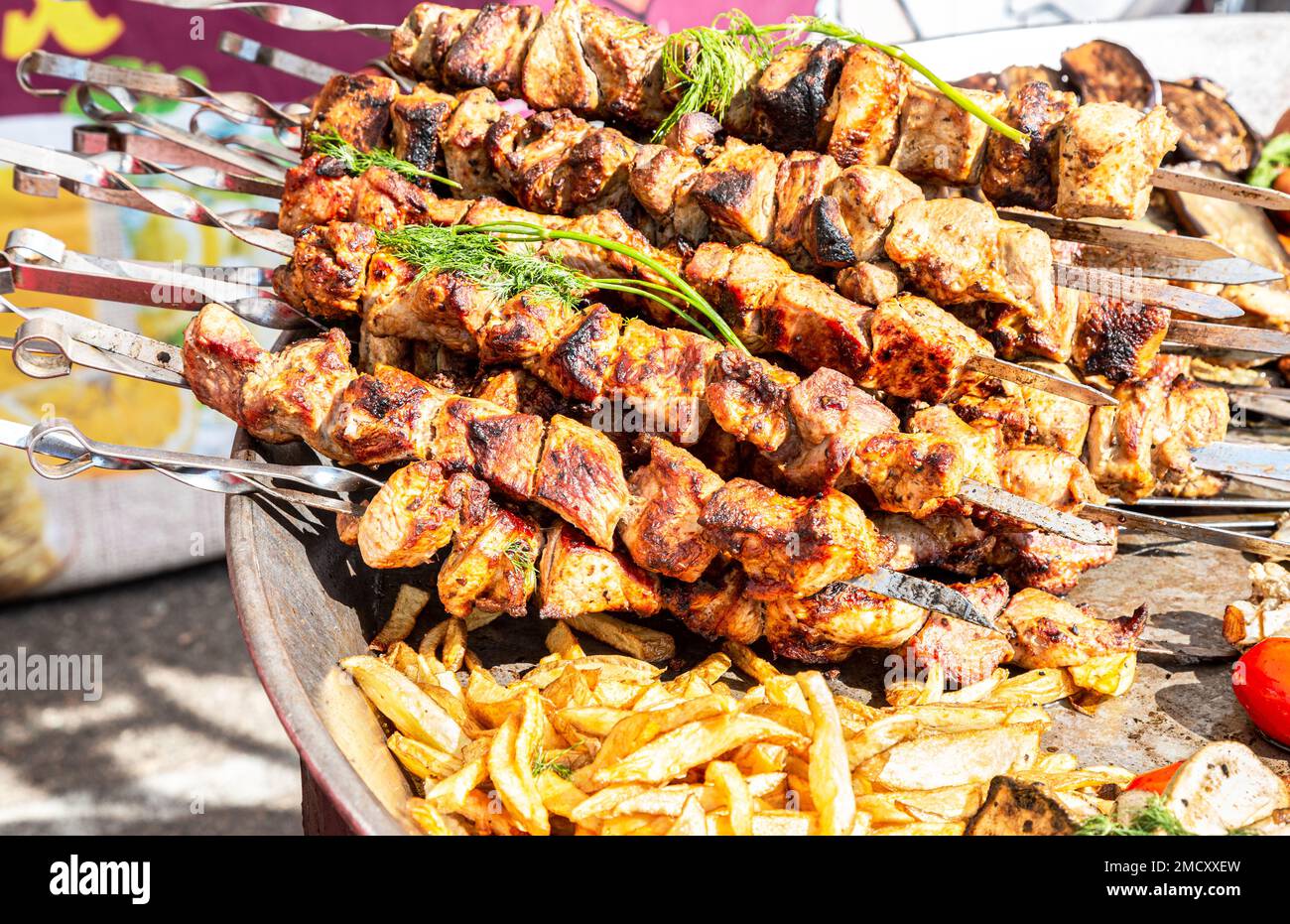 Grilled appetizing kebab cooking on metal skewers. Shashlik during of ...