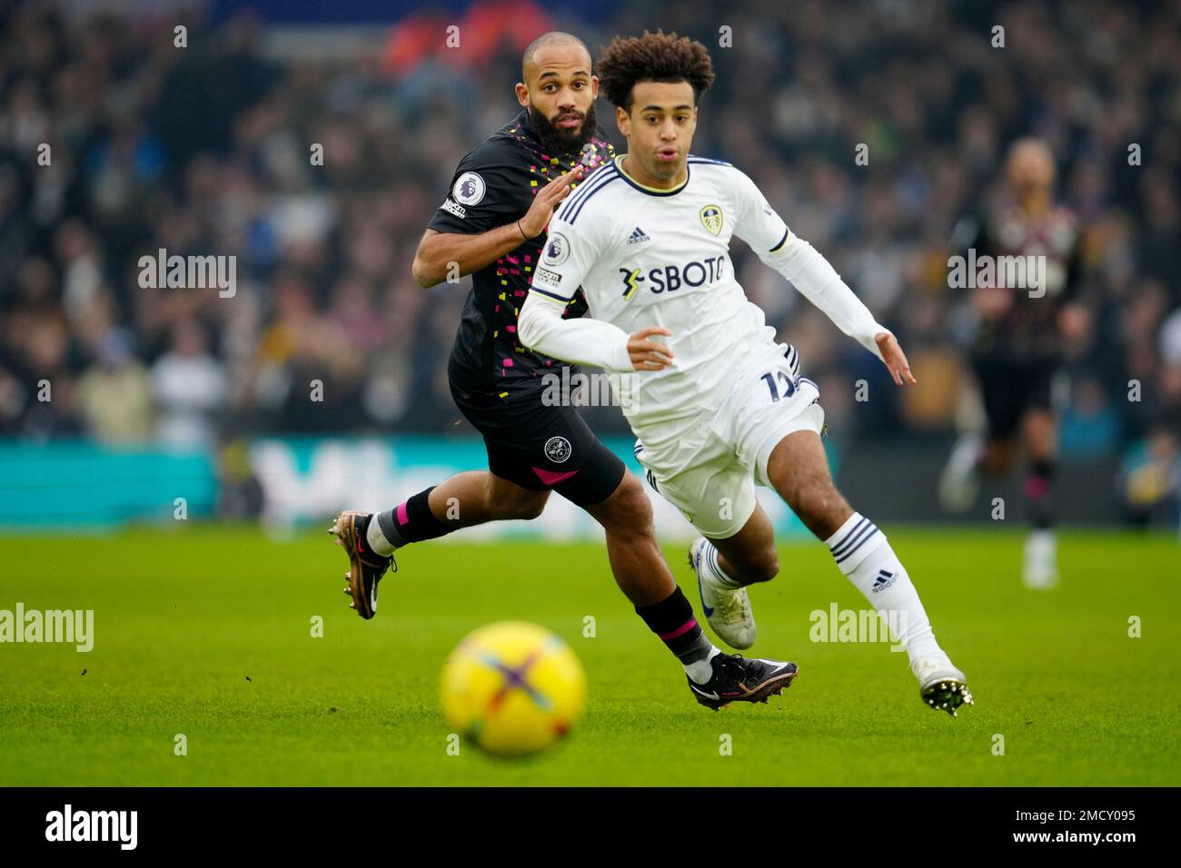 Brentford's Bryan Mbeumo, left, and Leeds United's Tyler Adams run ...