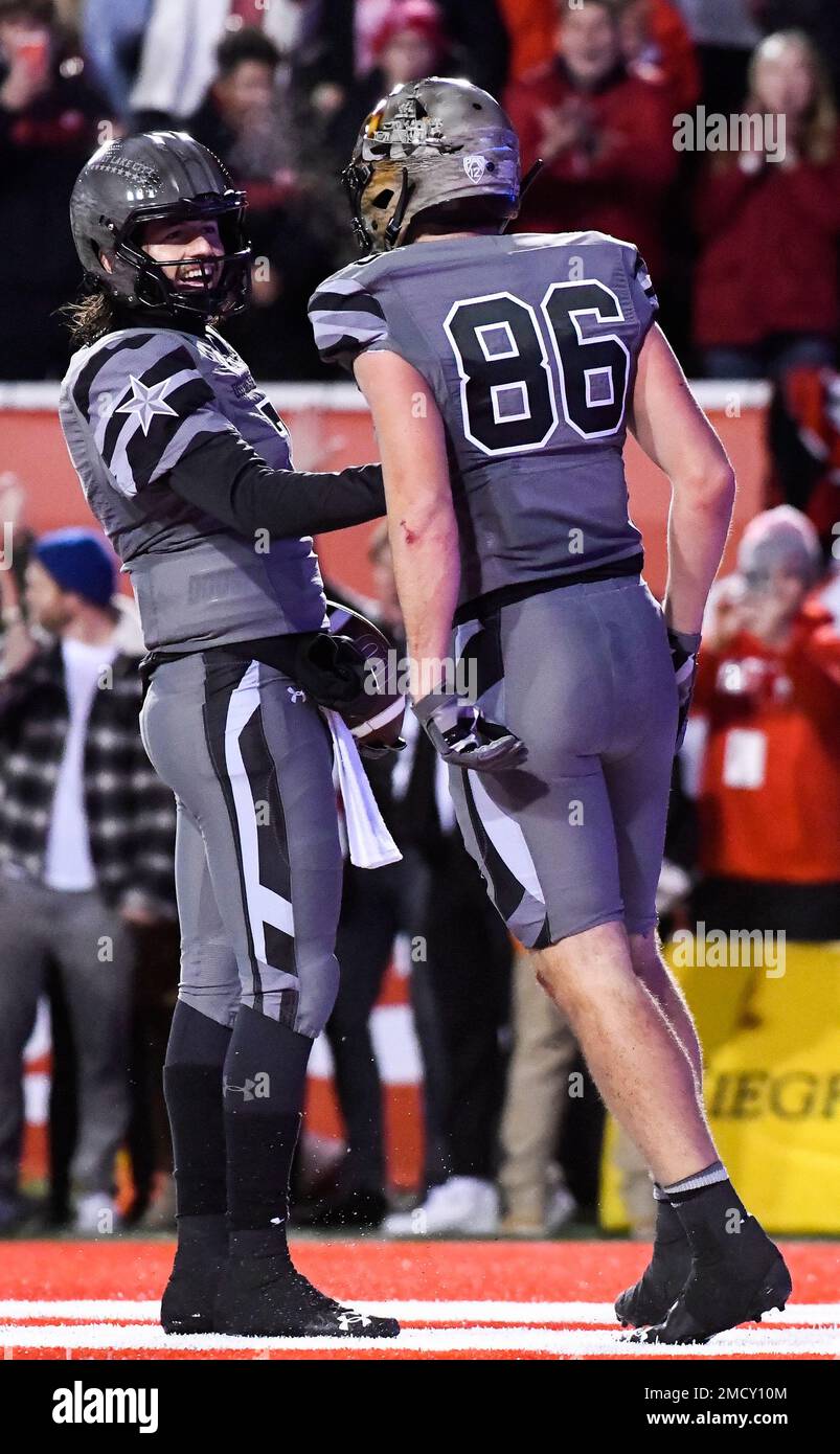 Utah quarterback Cameron Rising, left, celebrates scoring a touchdown ...