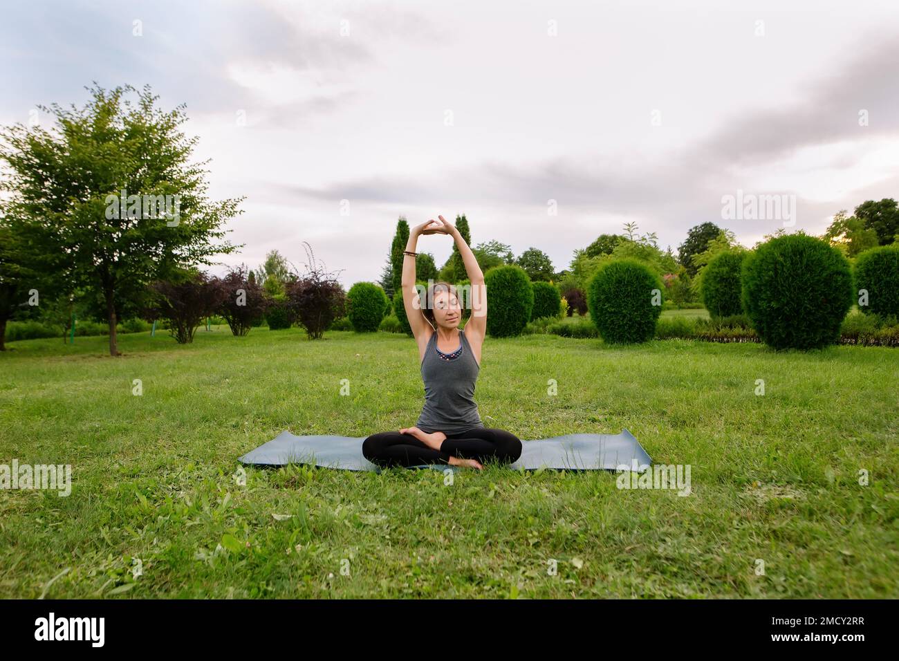 Caucasian woman, yoga instructor, doing side stretch, sitting spine ... Caucasian woman, yoga instructor, doing side stretch, sitting spine ...